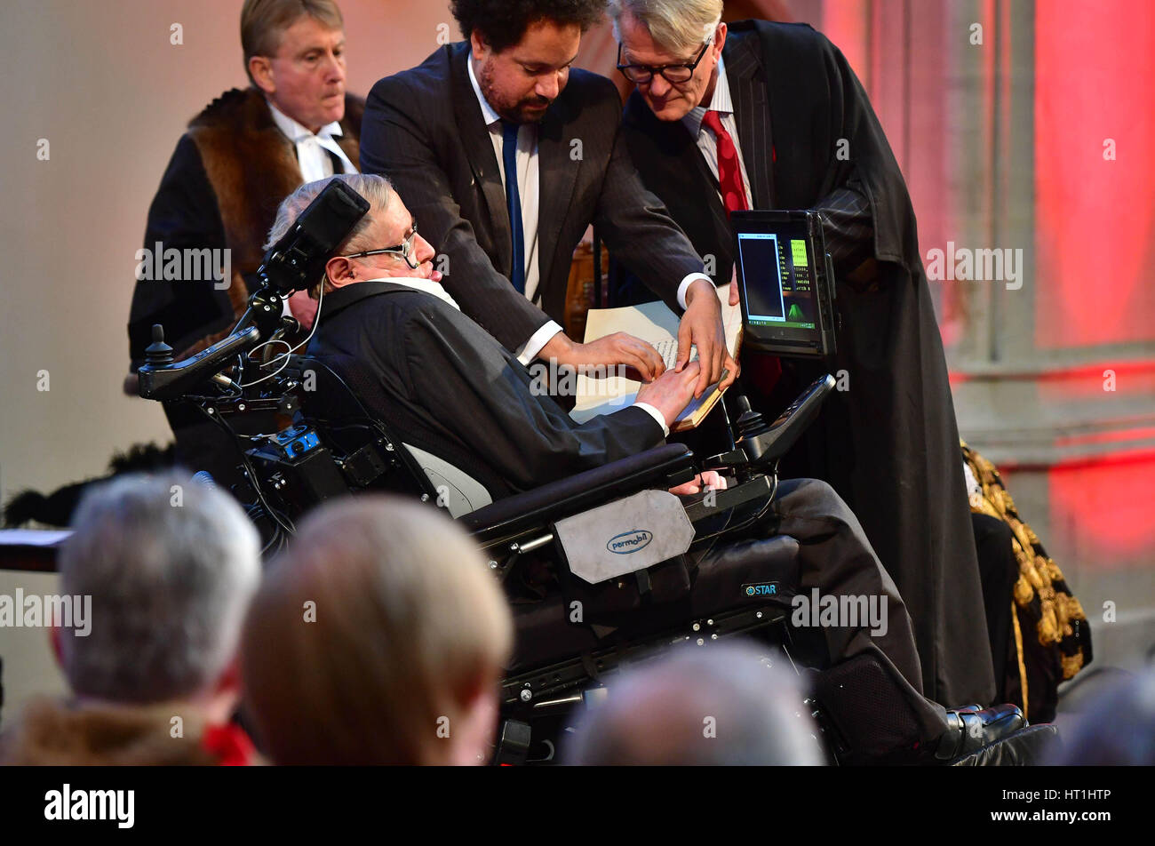 Professor Stephen Hawking signs the Roll of Honour as he receives the ...