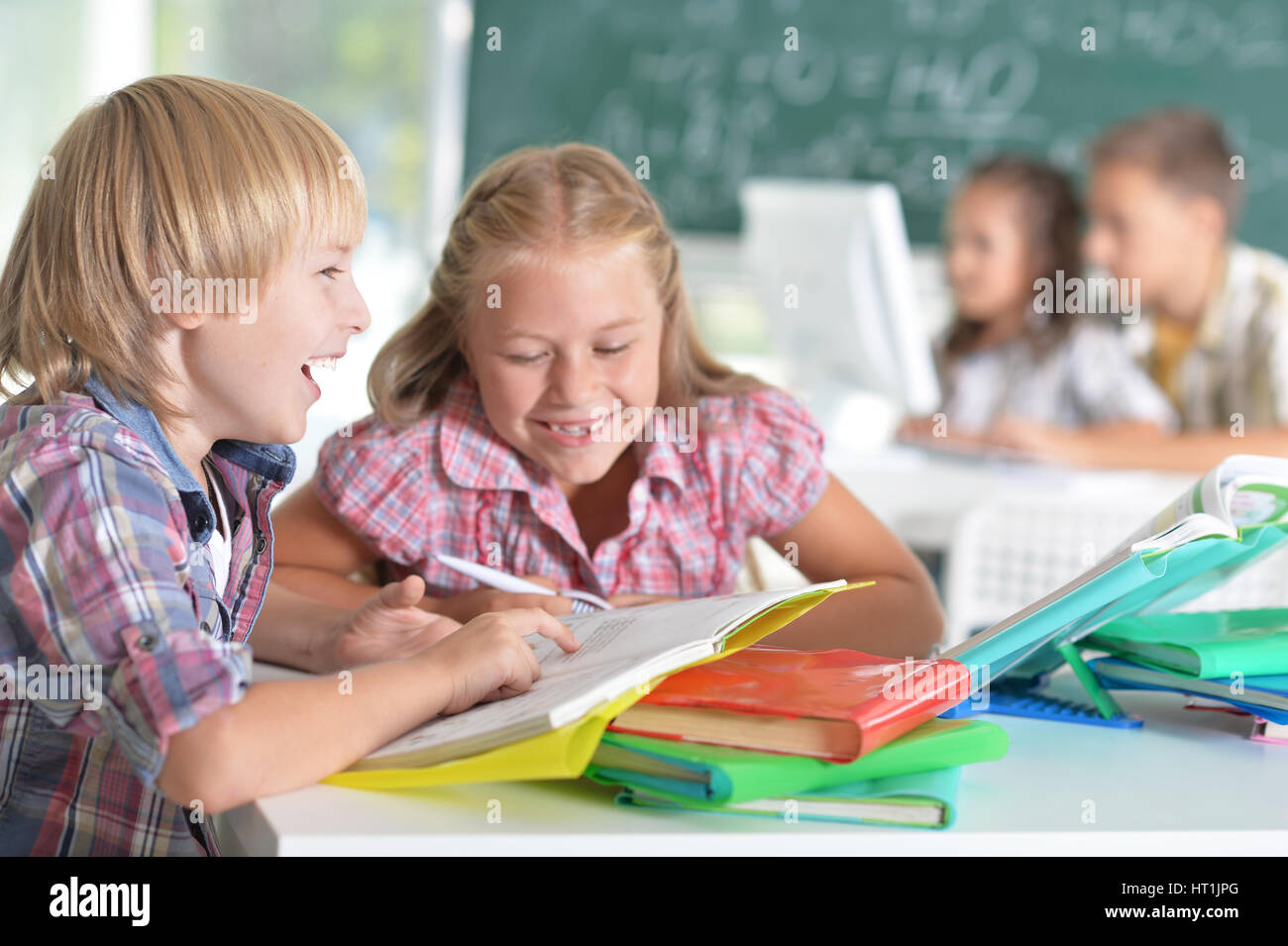 Portrait of girl and boy doing lessons Stock Photo - Alamy