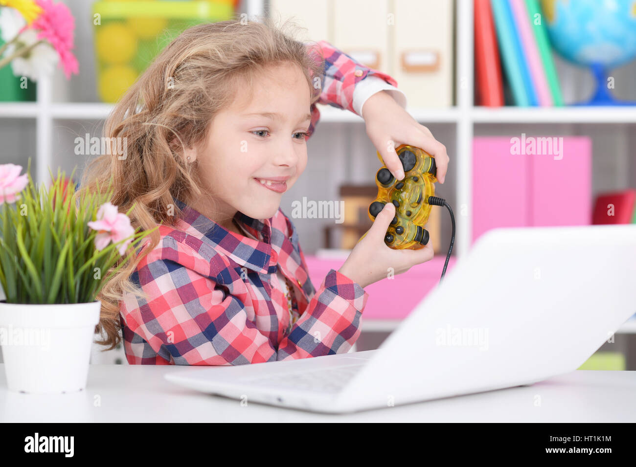 Little girl is playing a computer game Stock Photo - Alamy