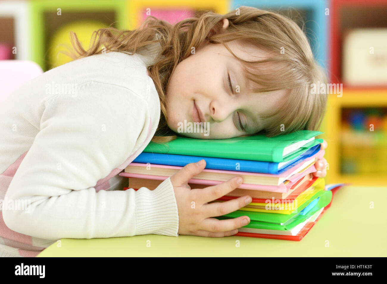 Portrait of a girl sleeping on books Stock Photo - Alamy