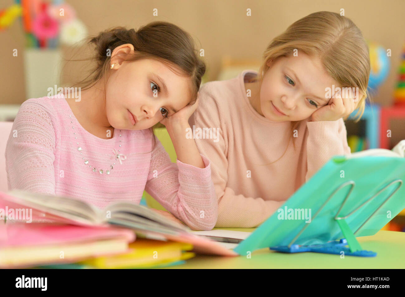Portrait of two girls with their homework Stock Photo - Alamy
