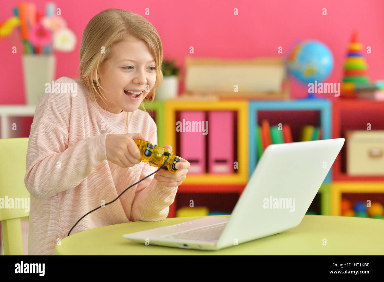 Little girl is playing a computer game Stock Photo - Alamy
