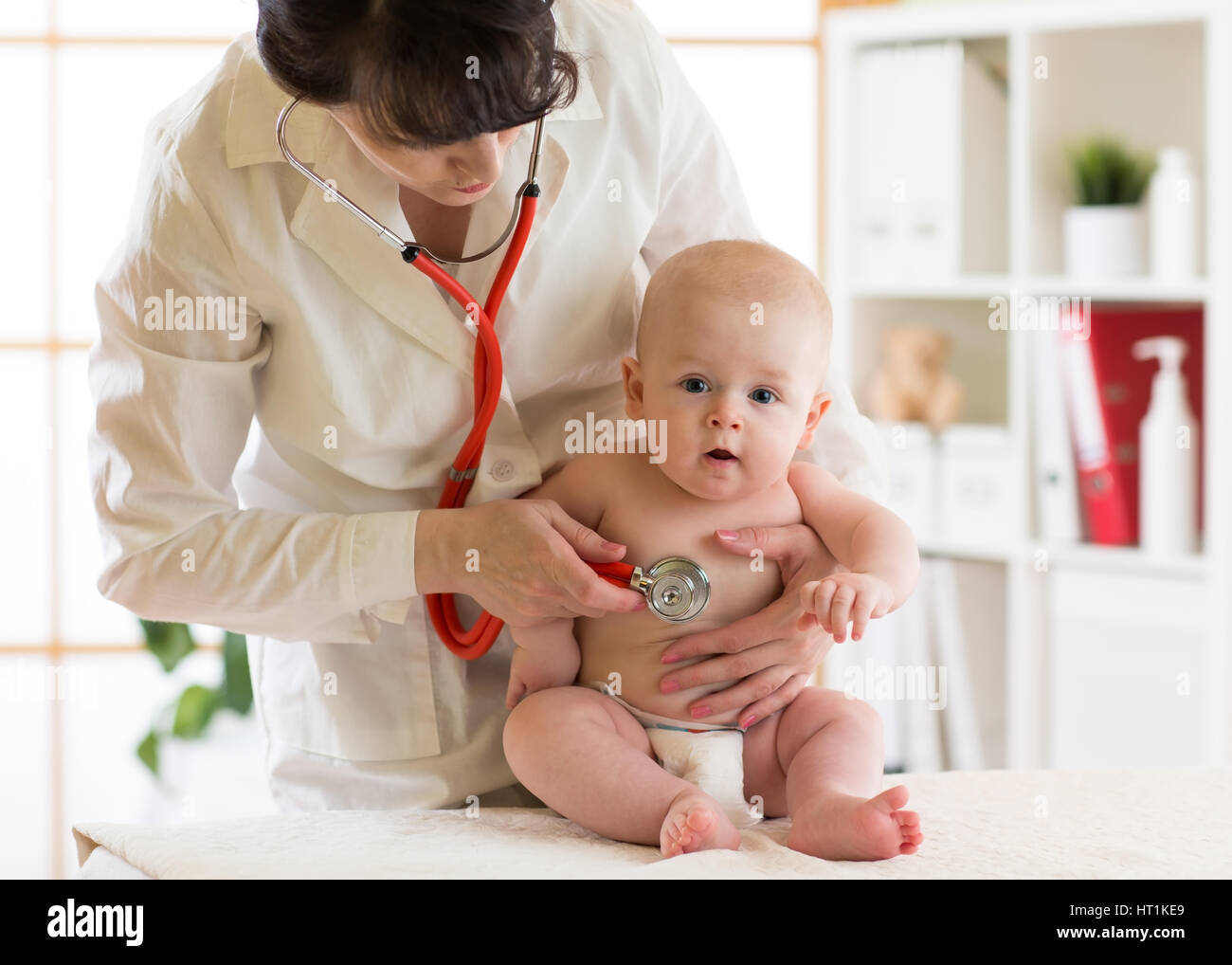 pediatrician doctor with baby kid in medical room Stock Photo - Alamy