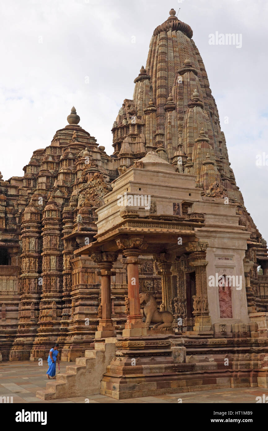 An attendant sweeps the plinth of the Devi Jagadamba temple, part of ...