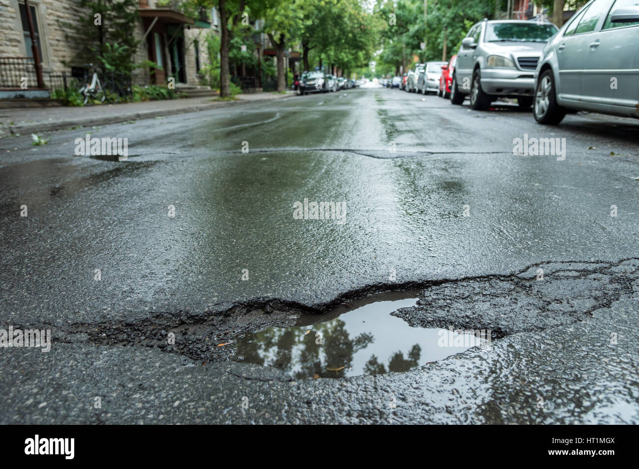 Large deep pothole in Montreal street, Canada Stock Photo - Alamy