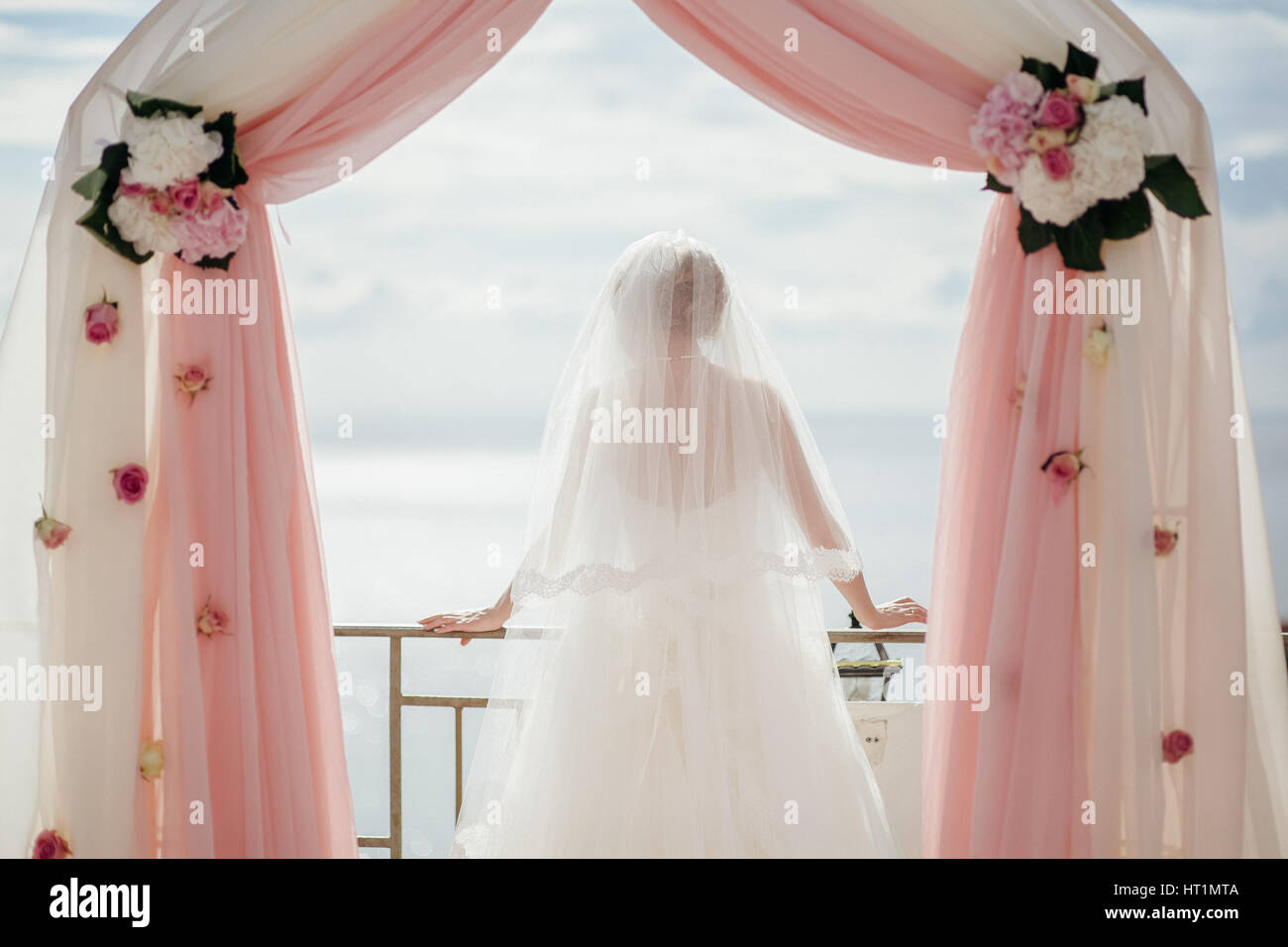 bride in wedding arch destination. Beautiful wedding arch and isle ...