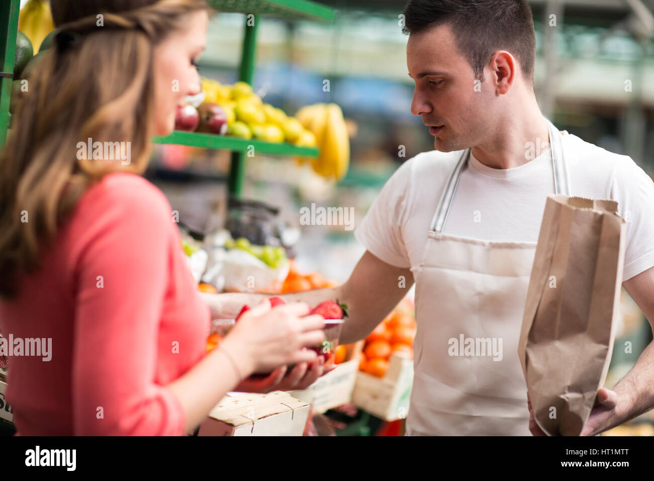 salesman holding paper bag in grocery Stock Photo - Alamy