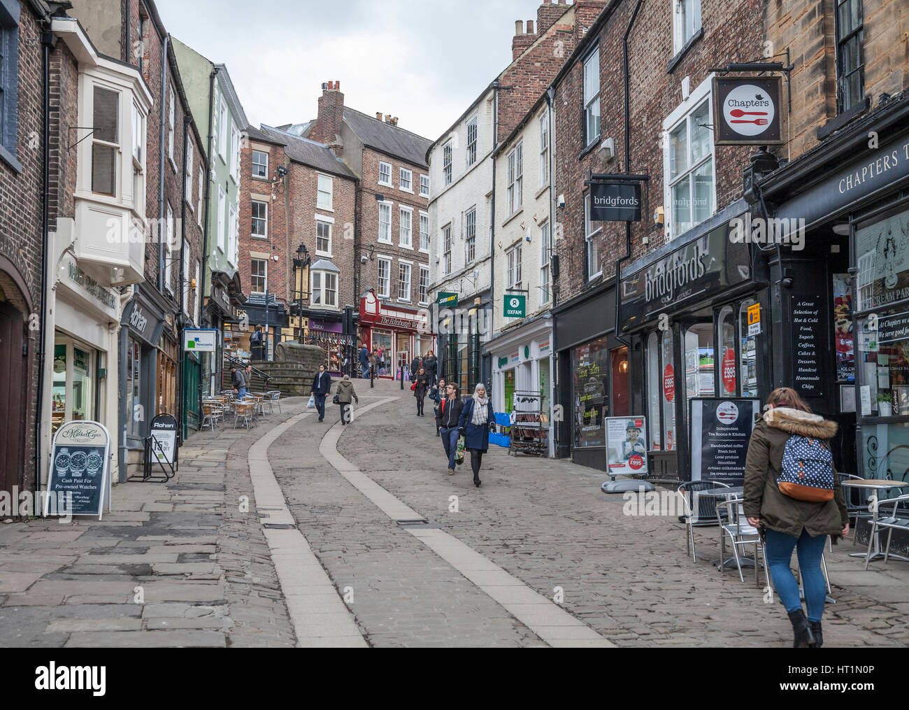Shoppers and tourists walking through Old Elvet street in Durham city ...