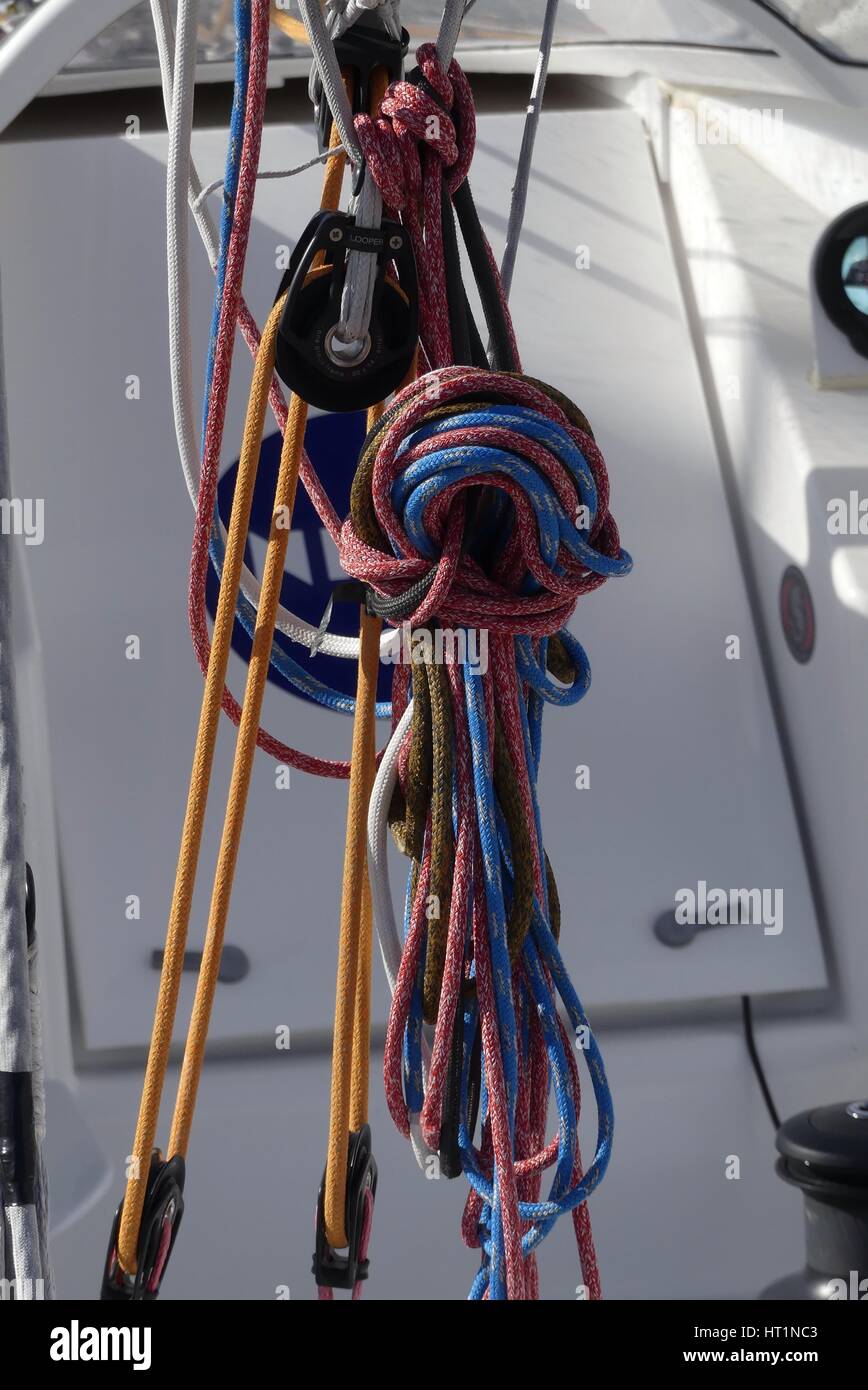 Closeup of hanging rigging ropes on board Ocean racer sailing boat ...