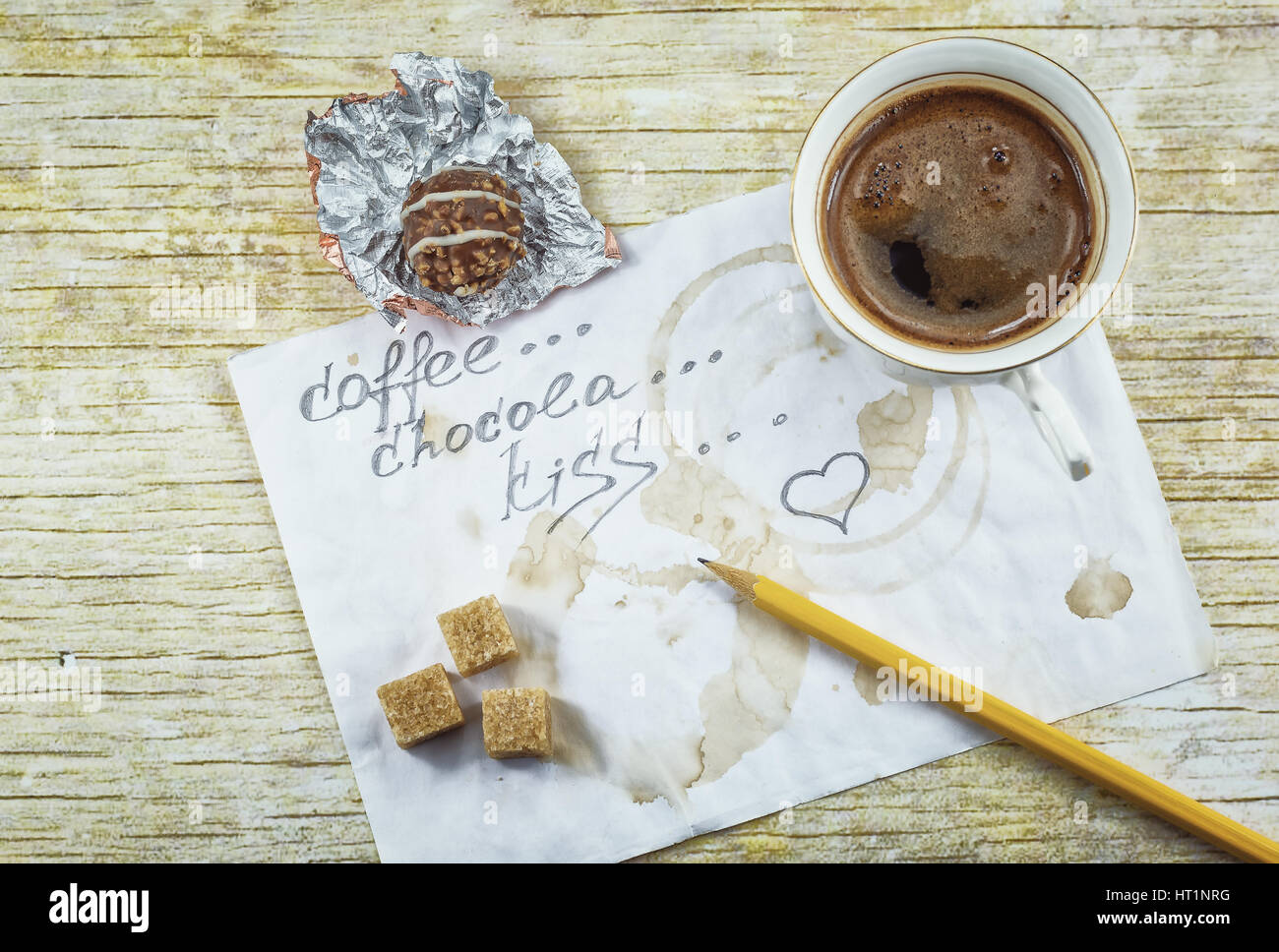 Сup of coffee, note, sweet, sugar, and a pencil on the table Stock ...