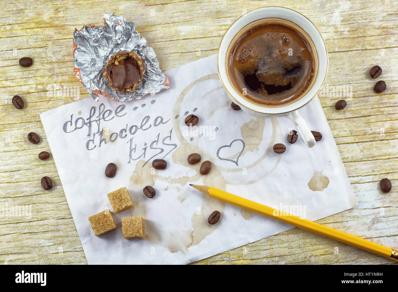 Сup of coffee, note, sweet, sugar, and a pencil on the table Stock ...