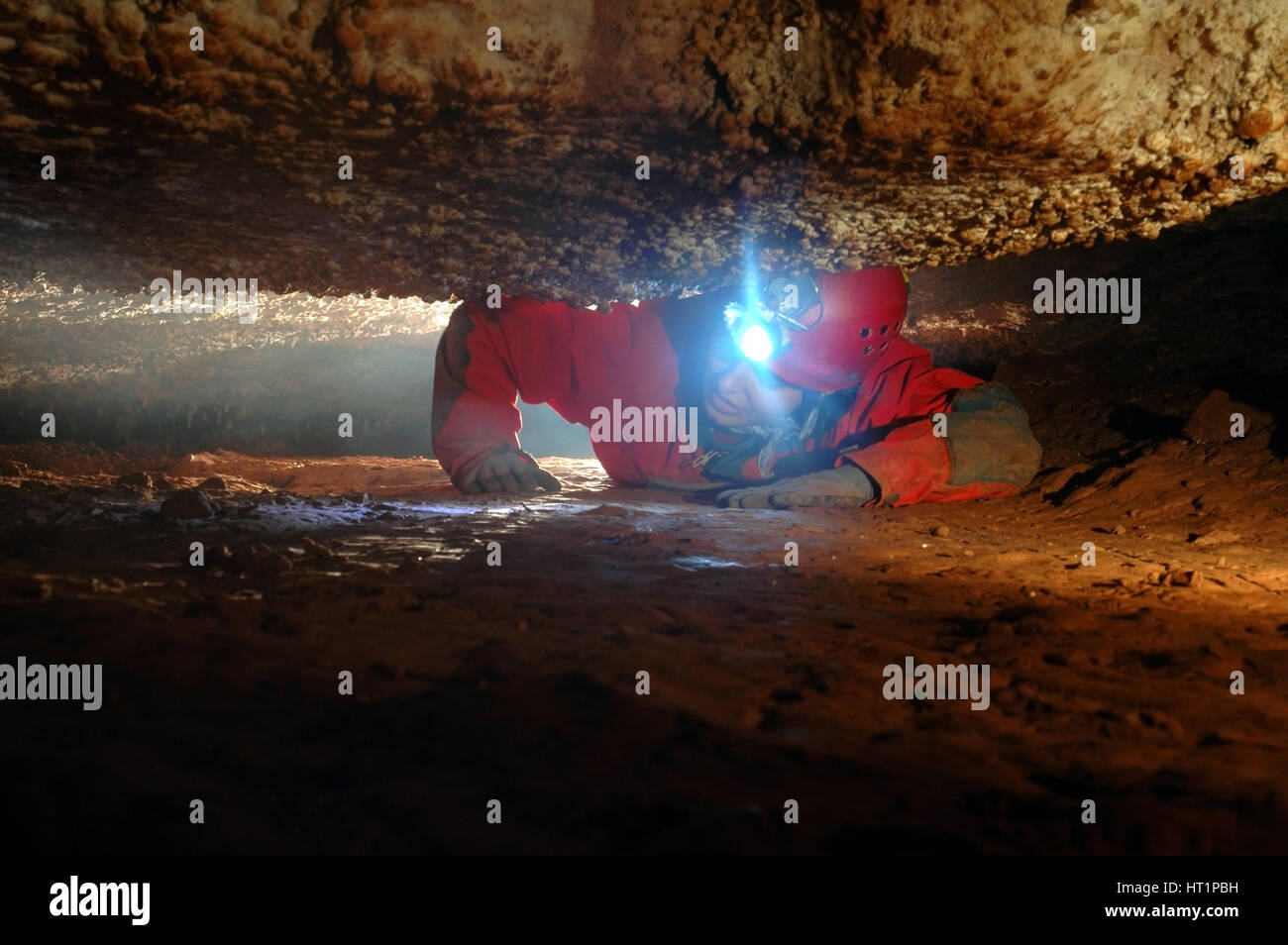 Narrow cave passage with a spelunker Stock Photo - Alamy