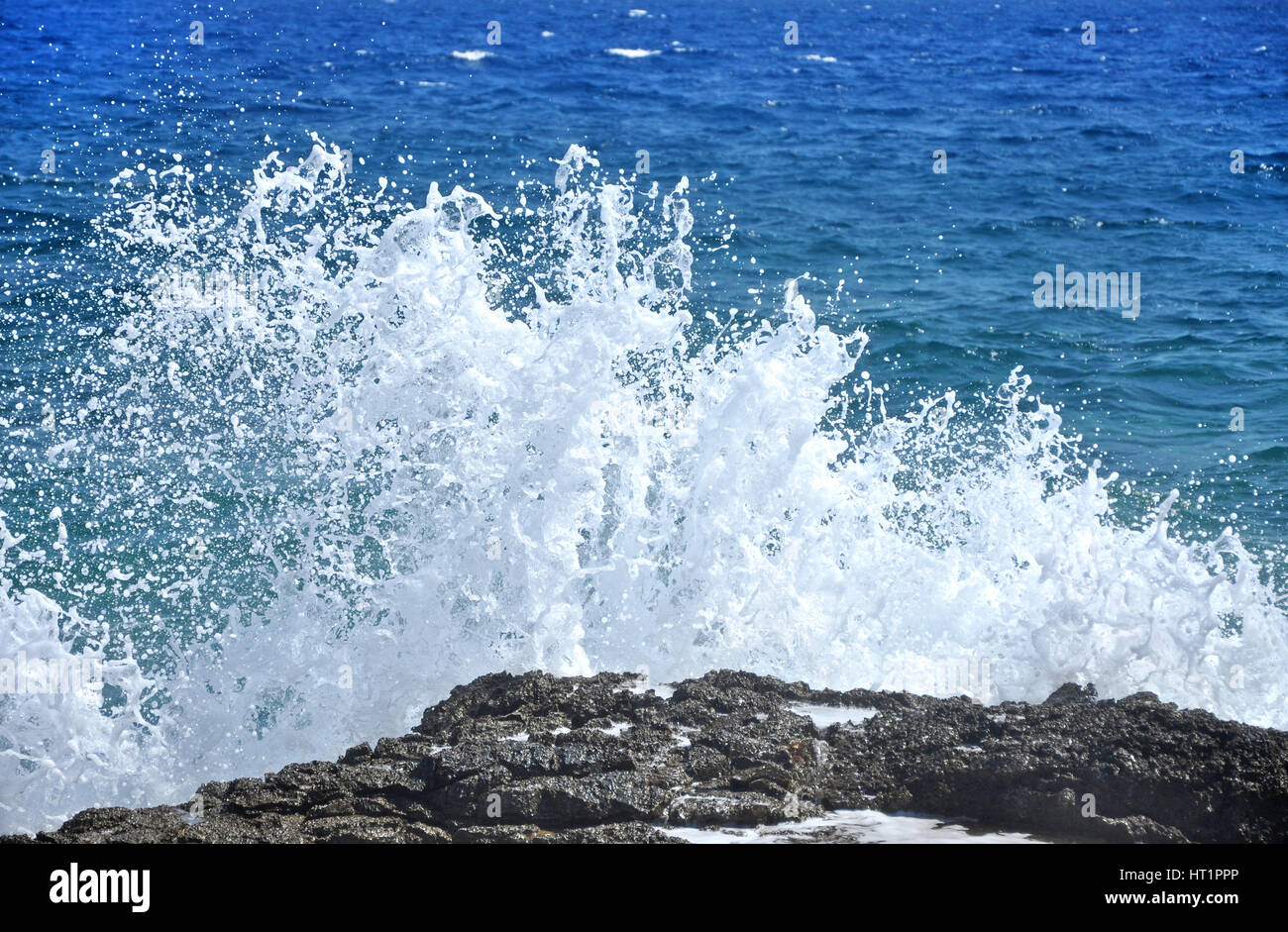 Rocky coast with splashing waves Stock Photo - Alamy