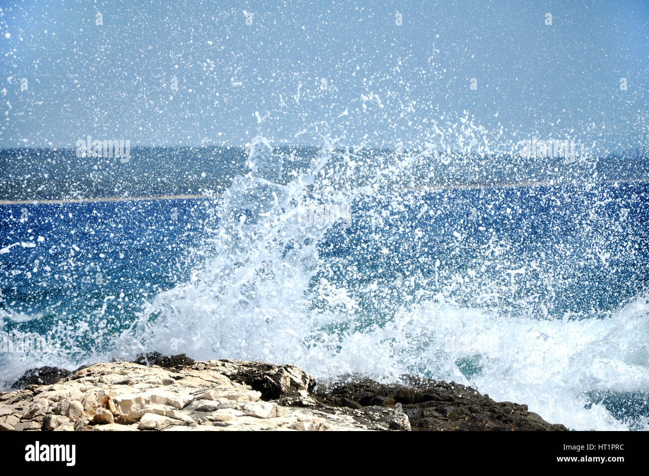 Rocky coast with splashing waves Stock Photo - Alamy
