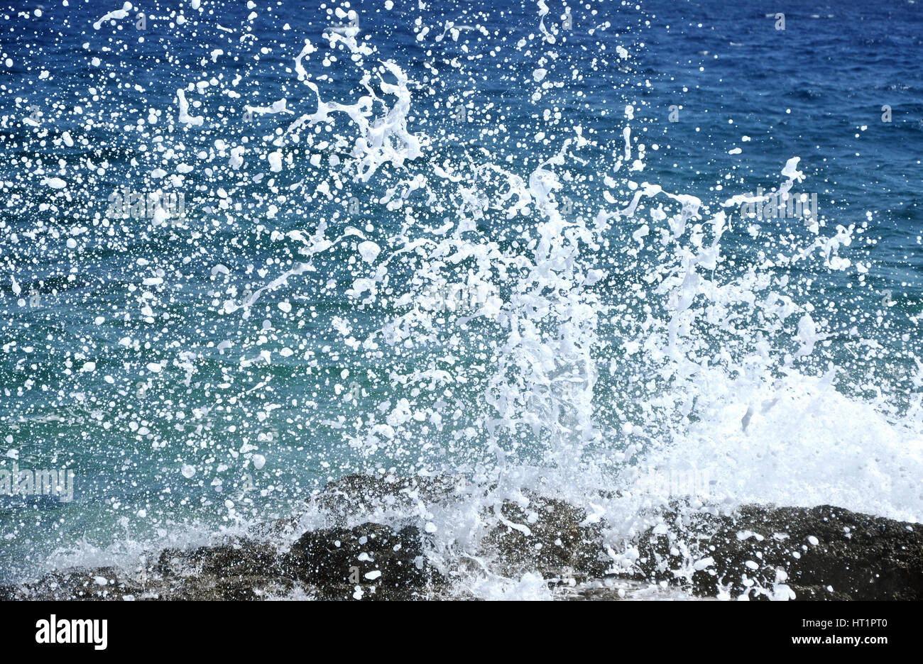 Rocky coast with splashing waves Stock Photo - Alamy