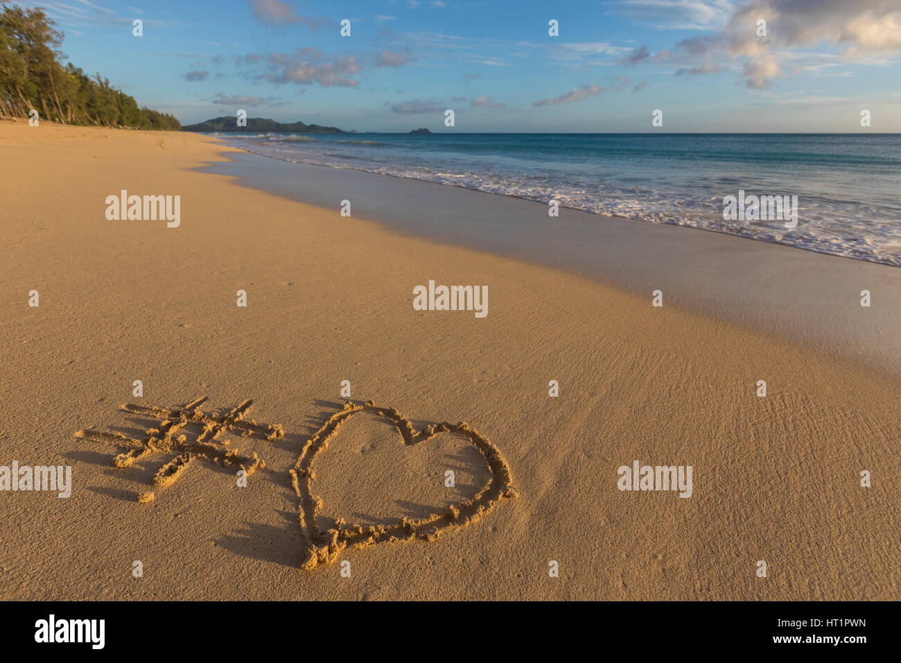A hashtag and heart drawn in the sand on a beach Stock Photo - Alamy