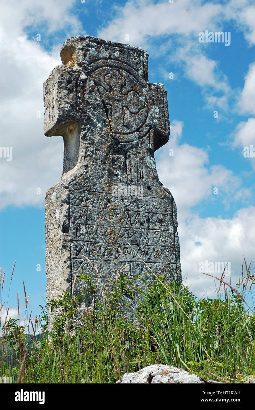 Abandoned stone cross landmark in the mountains Stock Photo - Alamy