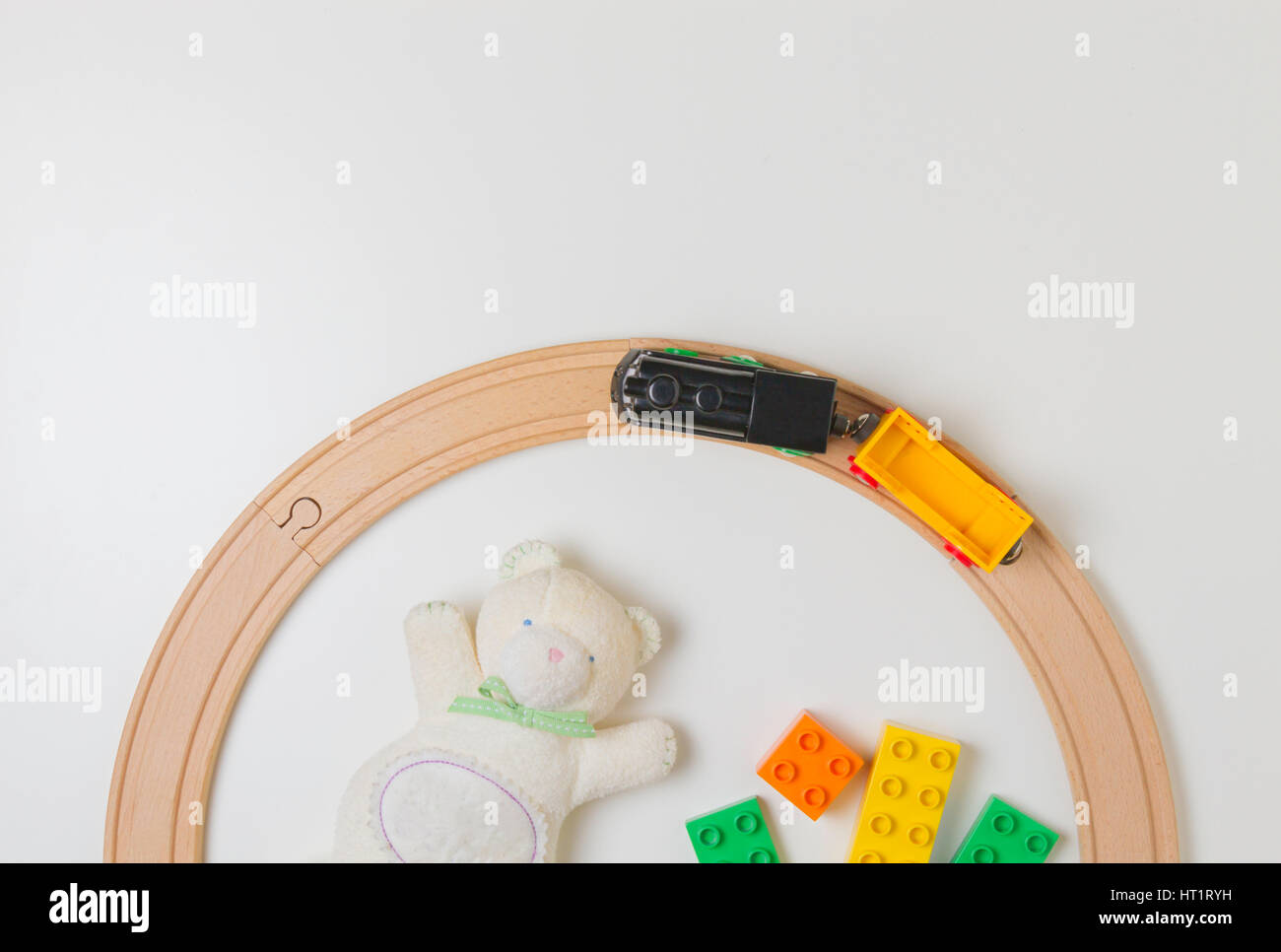 Toys frame with teddy, plastic bricks and toy train on the white ...