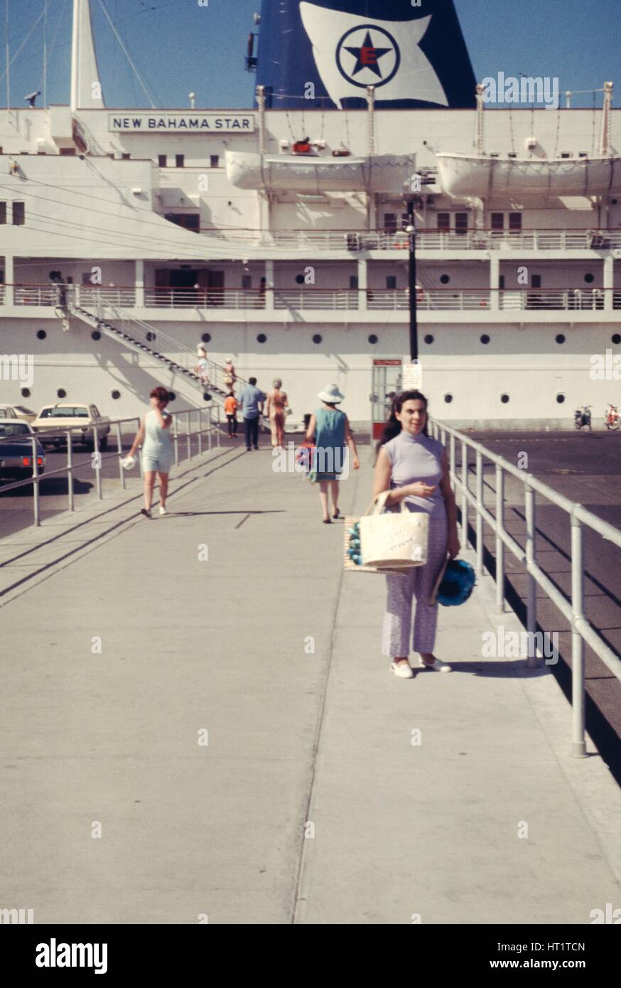 Female tourist standing in front of the New Bahama Star cruise ship ...