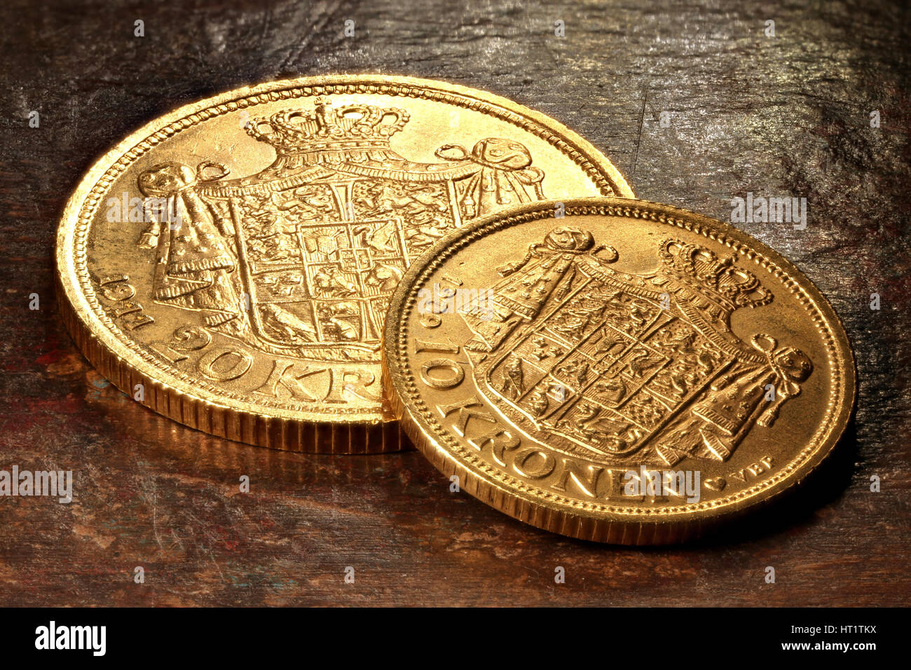 Danish gold coins on rustic wooden background Stock Photo - Alamy