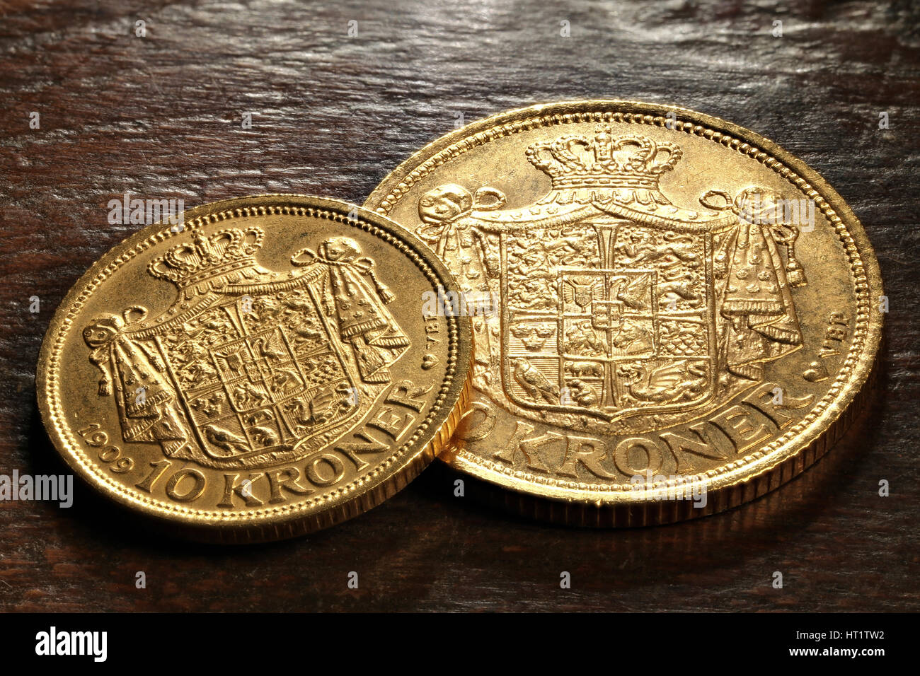 Danish gold coins on rustic wooden background Stock Photo - Alamy