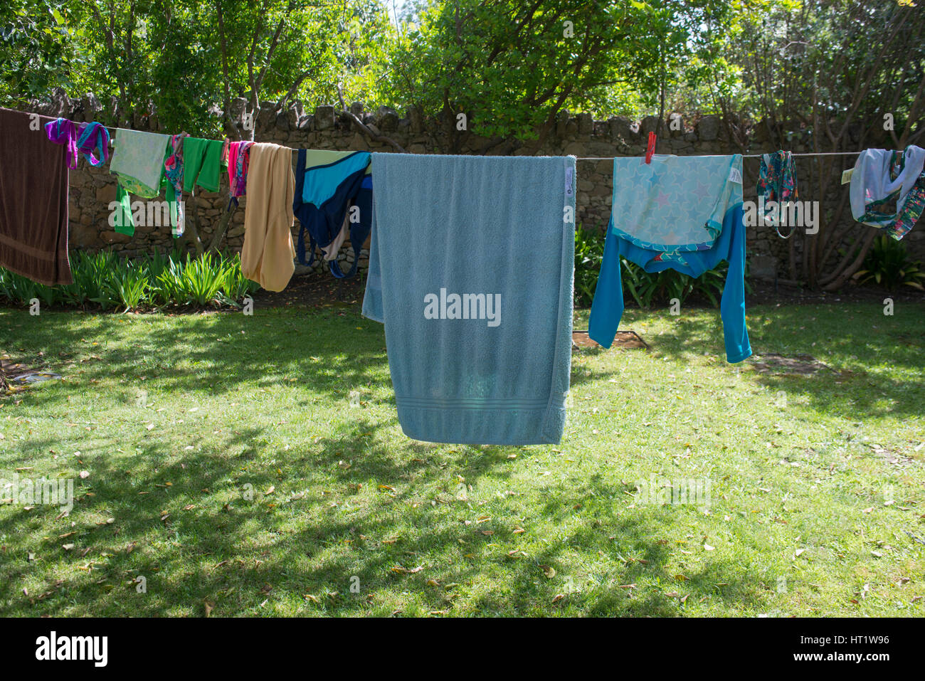 Wet towels and clothes are drying in the garden Stock Photo - Alamy