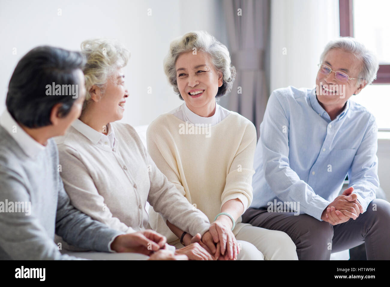 Happy senior friends talking Stock Photo - Alamy