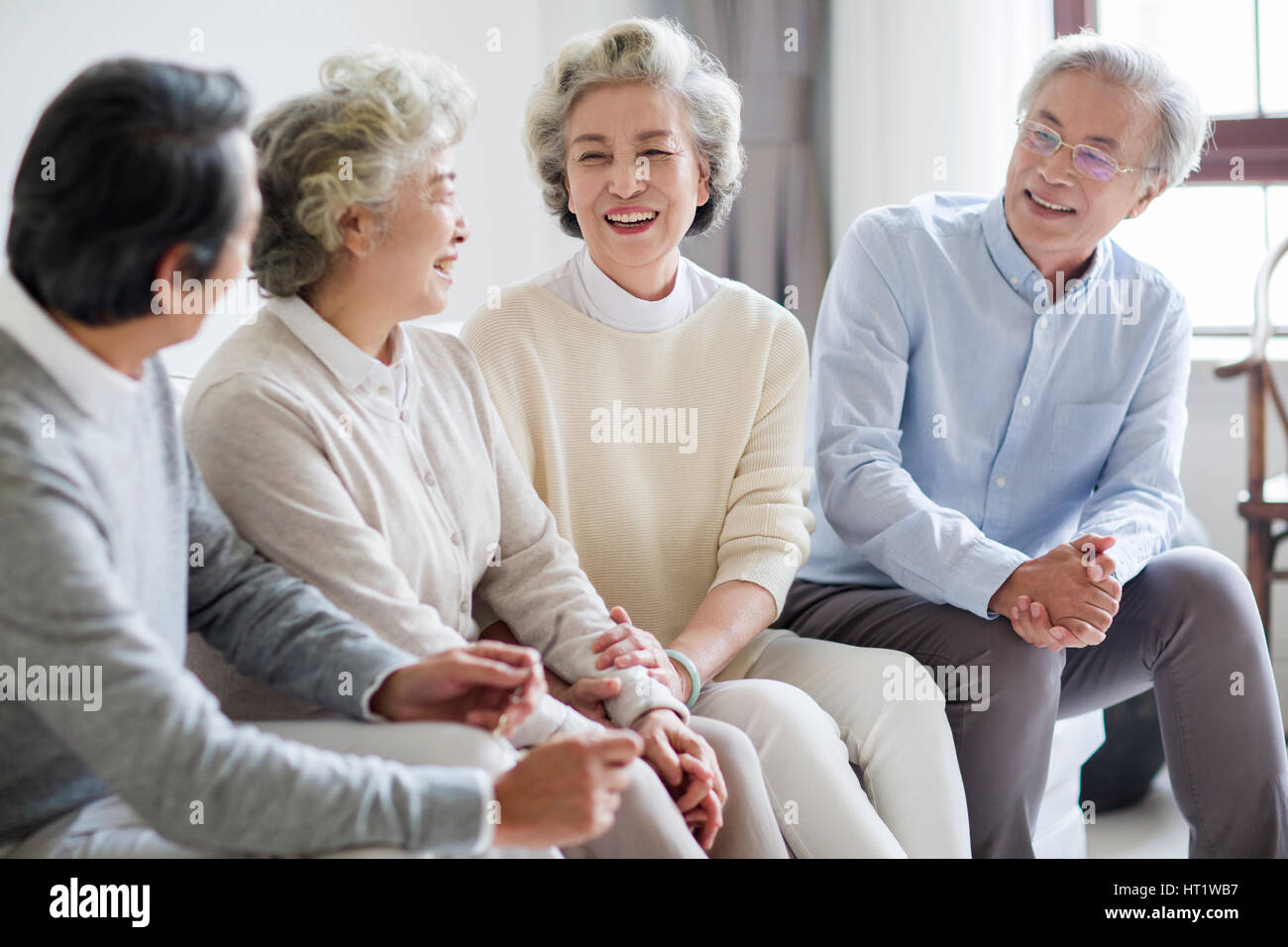 Happy senior friends talking Stock Photo - Alamy