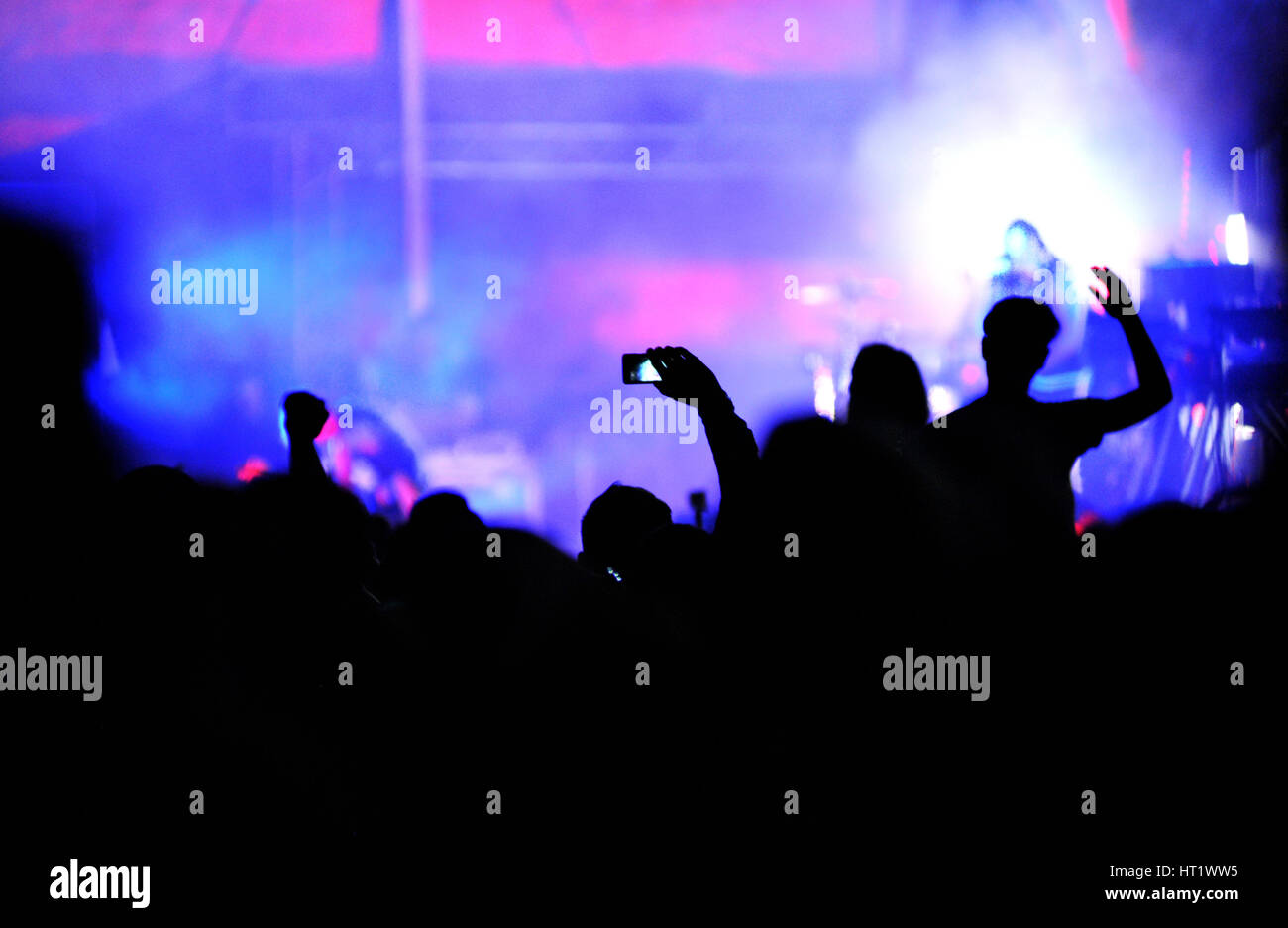 Crowd of partying people taking photos with smartphone at Electric ...