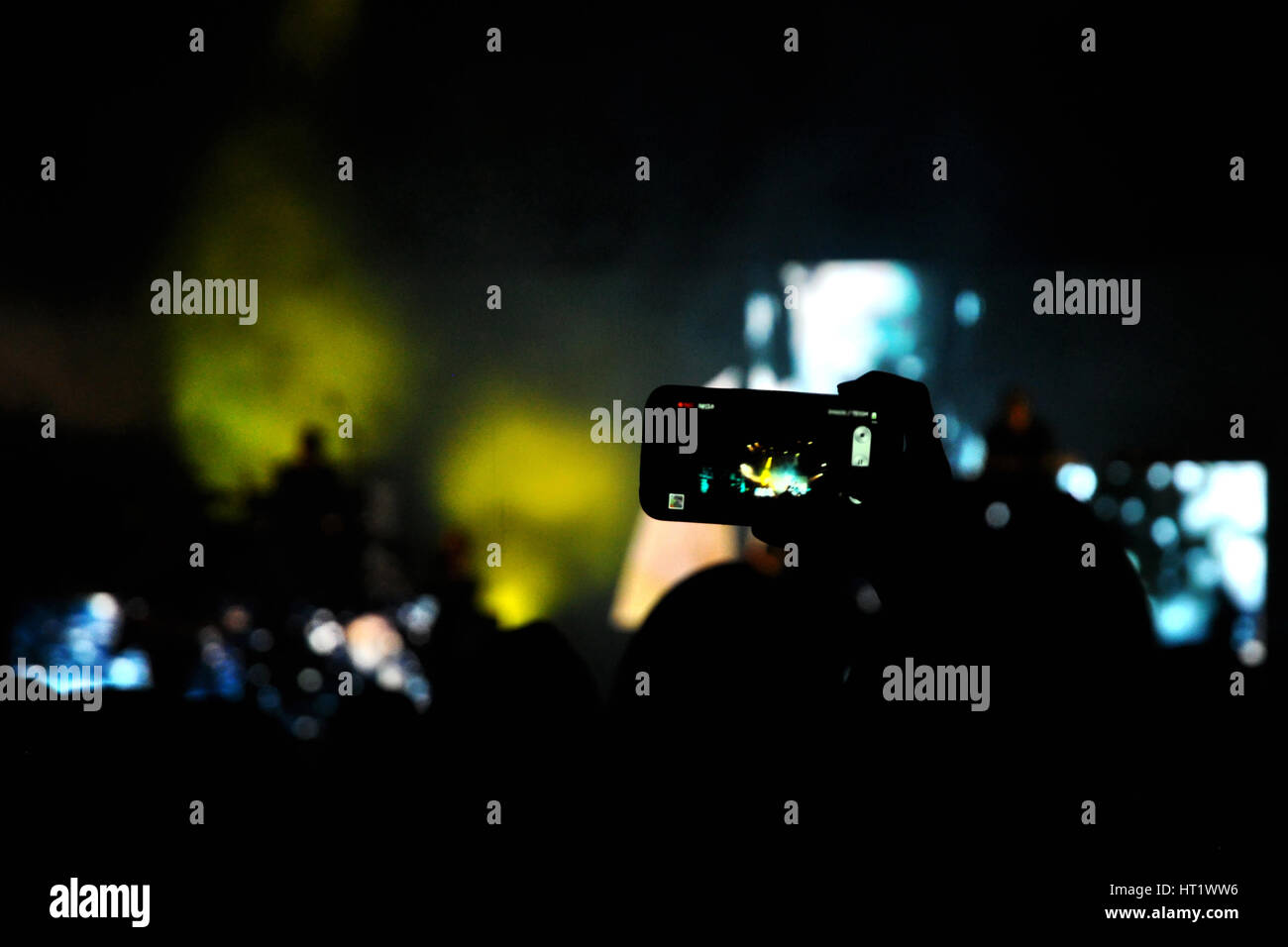 Crowd of partying people taking photos with smartphone at Electric ...