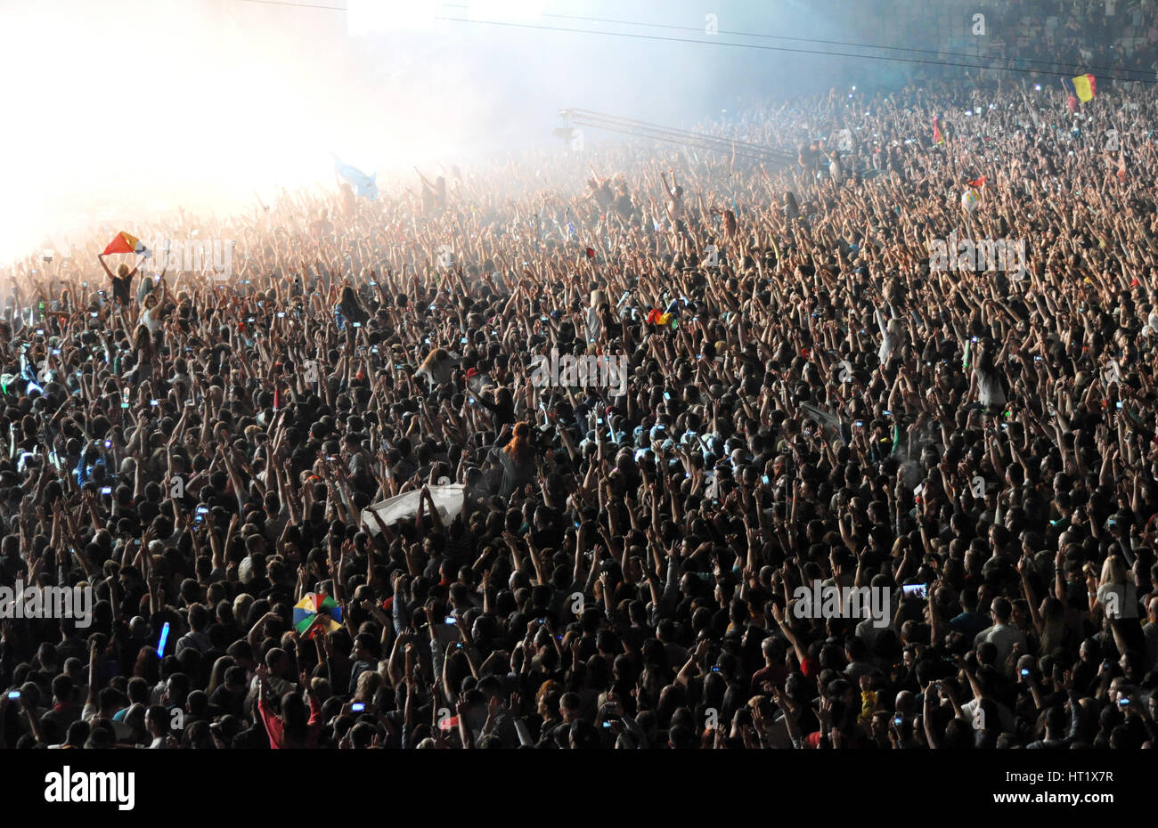 CLUJ NAPOCA, ROMANIA – JULY 31, 2015: Crowd of party people raising ...