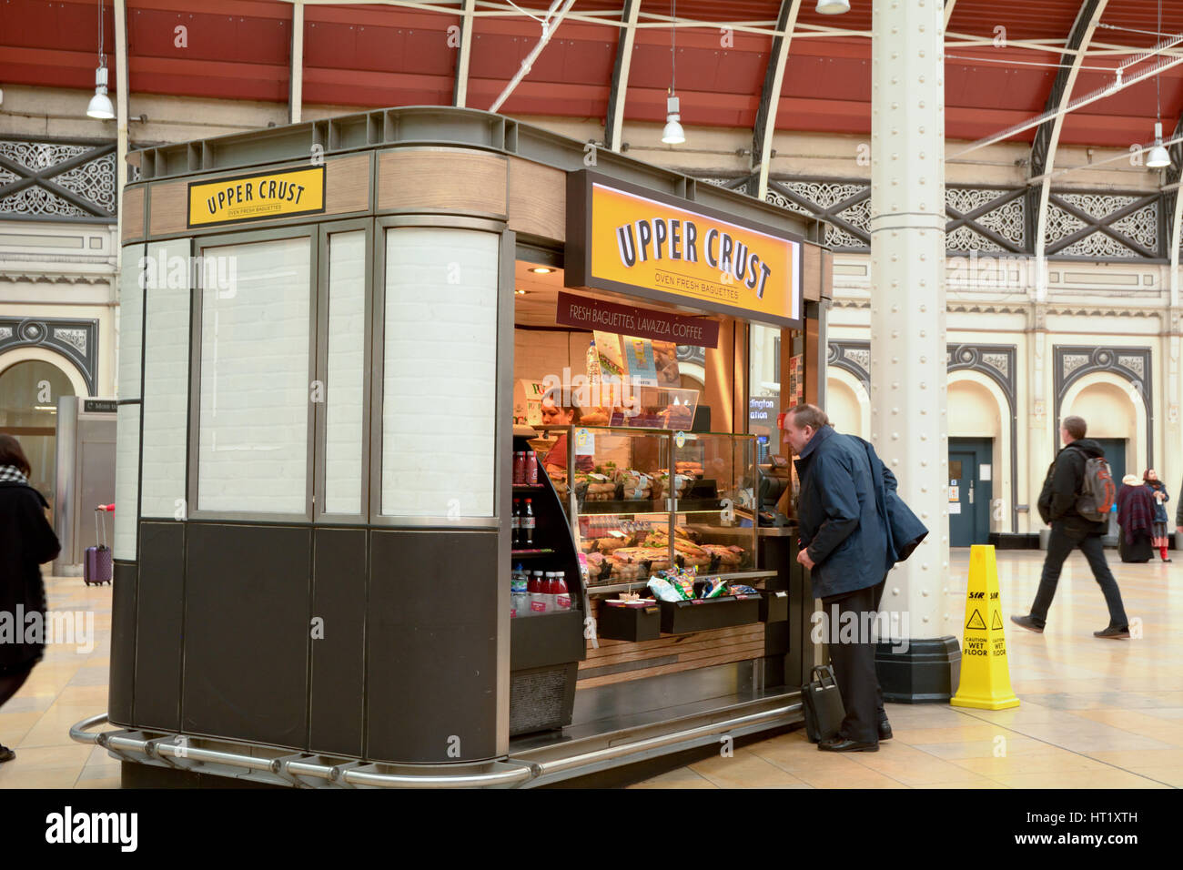 Man buying some food for his train journey from an Upper Crust sandwich ...