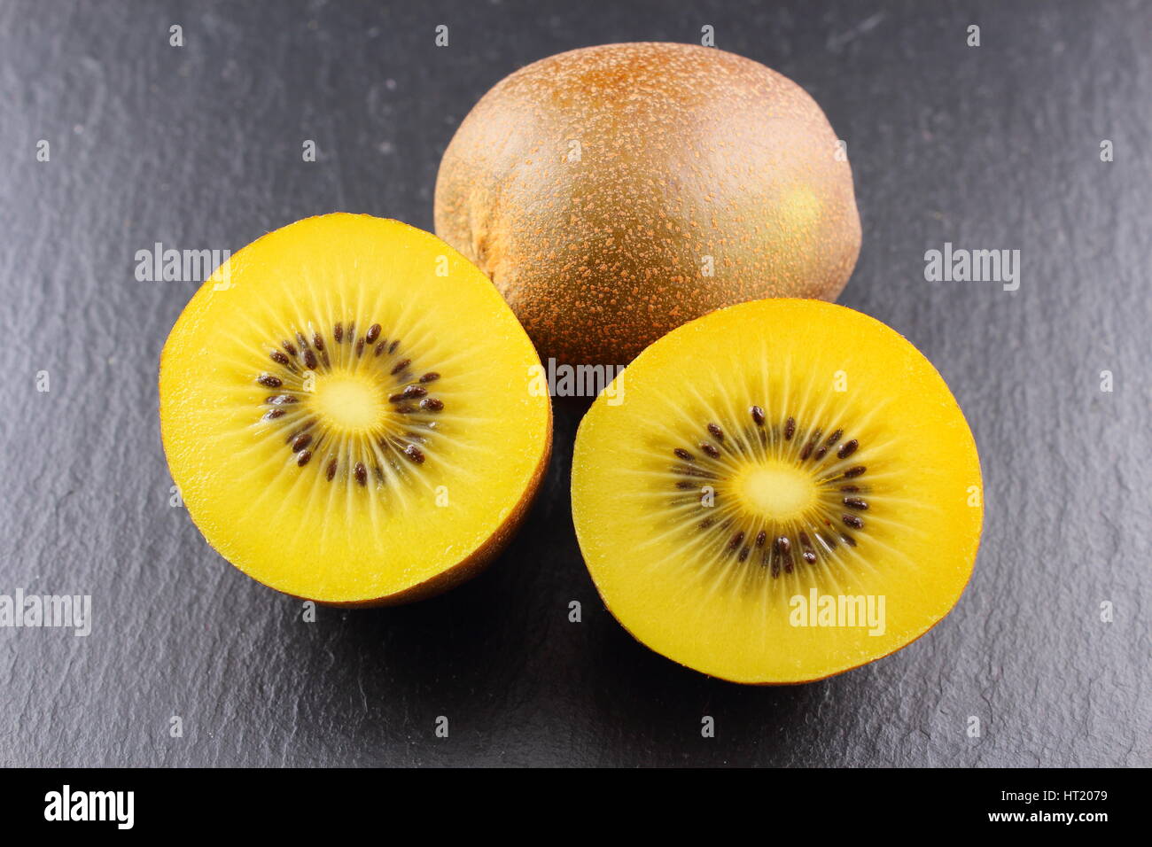 composition of fresh yellow kiwi fruits on a slate plate Stock Photo ...