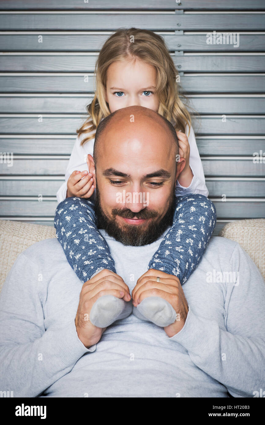 Happy family concept, father and daughter portrait, sitting on a couch ...