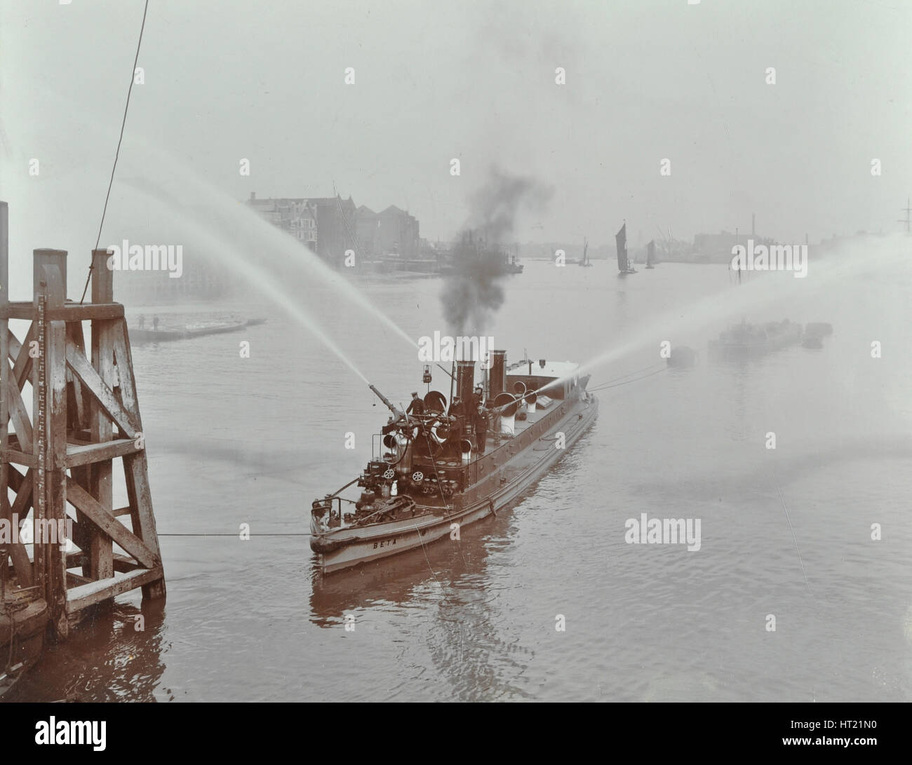 The 'Beta' fire float with hoses, River Thames, London, 1910. Artist ...