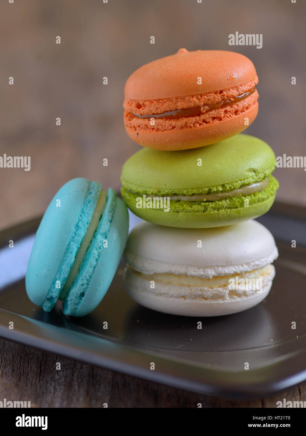 french colorful macarons on wooden table Stock Photo - Alamy