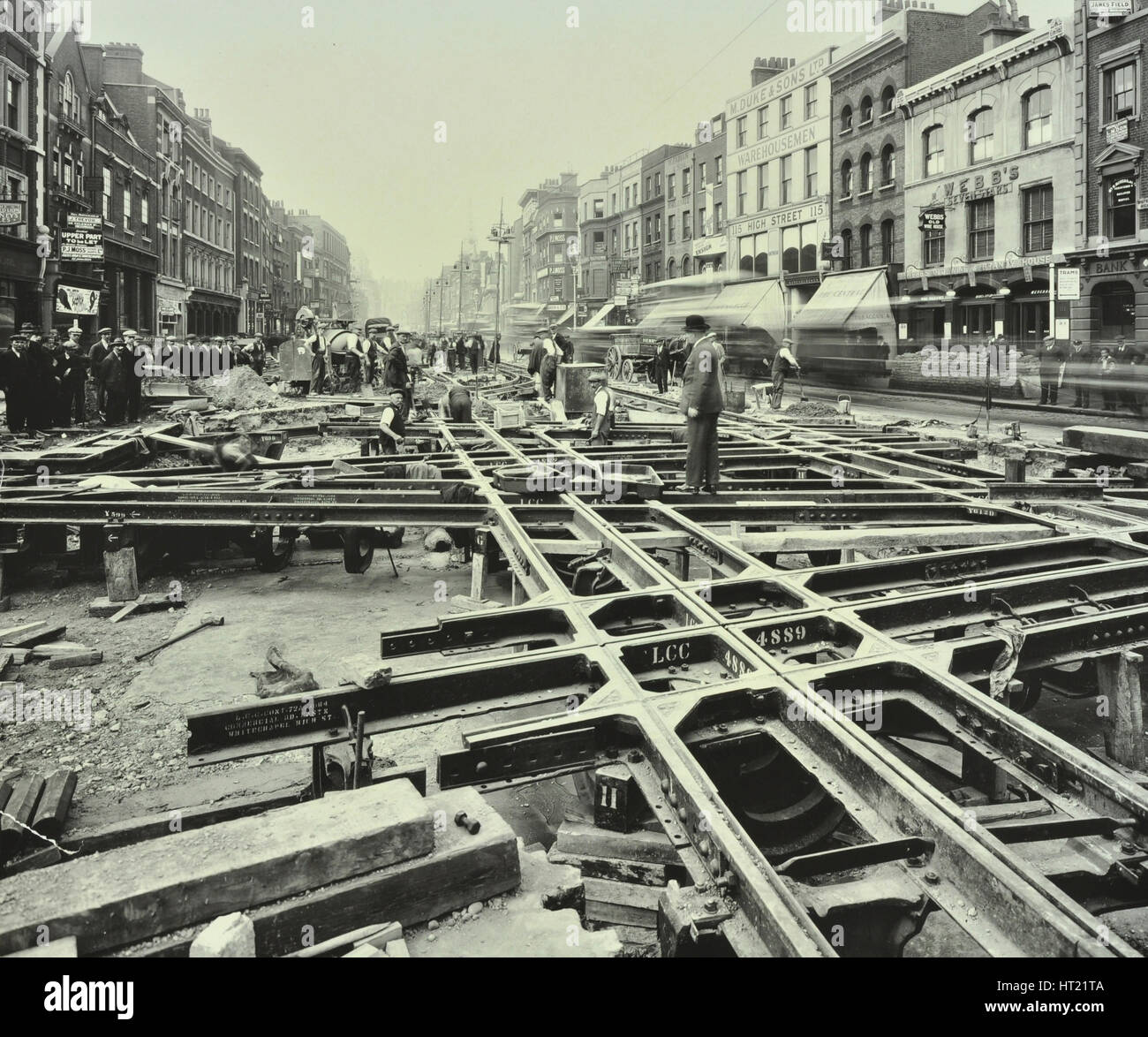 Men laying tramlines at a junction, Whitechapel High Street, London ...