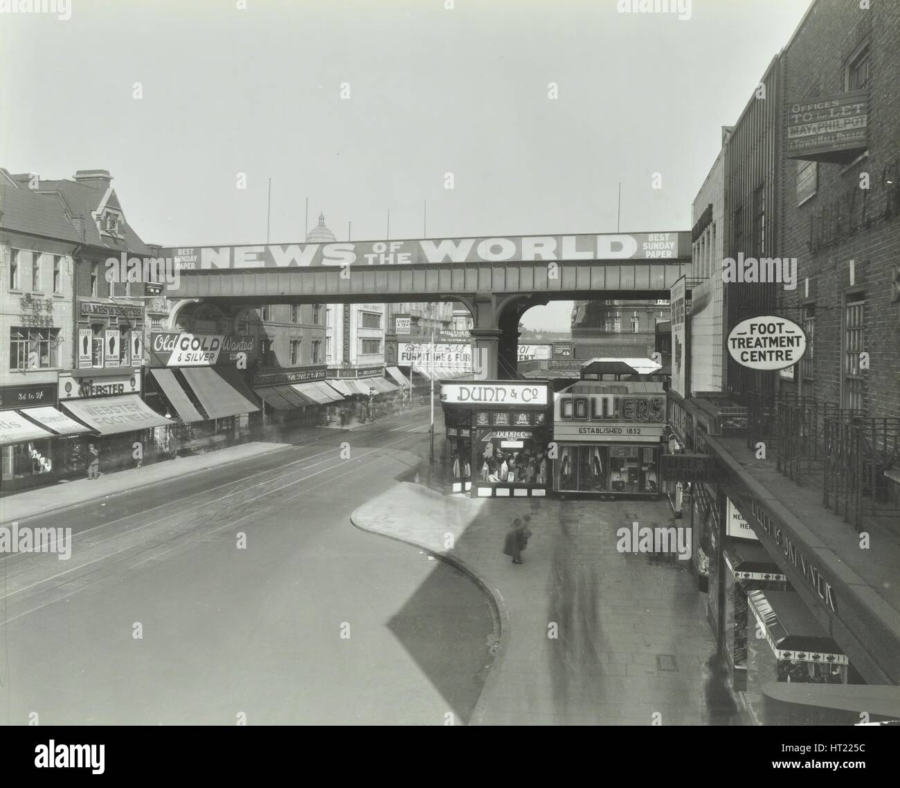 Railway bridge and advertising over the Brixton Road, Lambeth, London ...