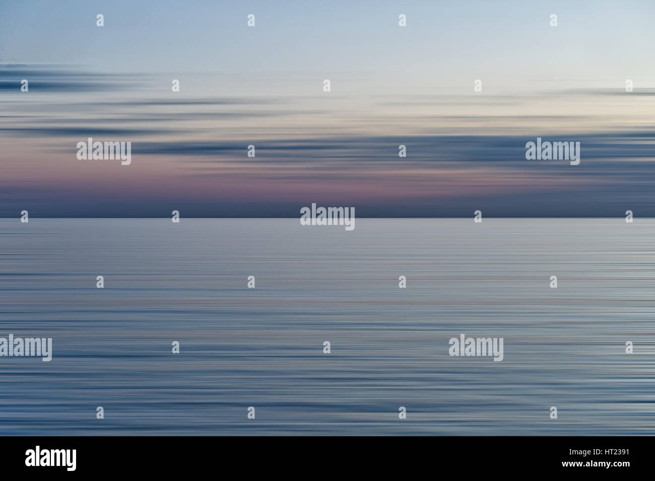 Colorful sunset with long exposure effect, horizontal motion blurred ...