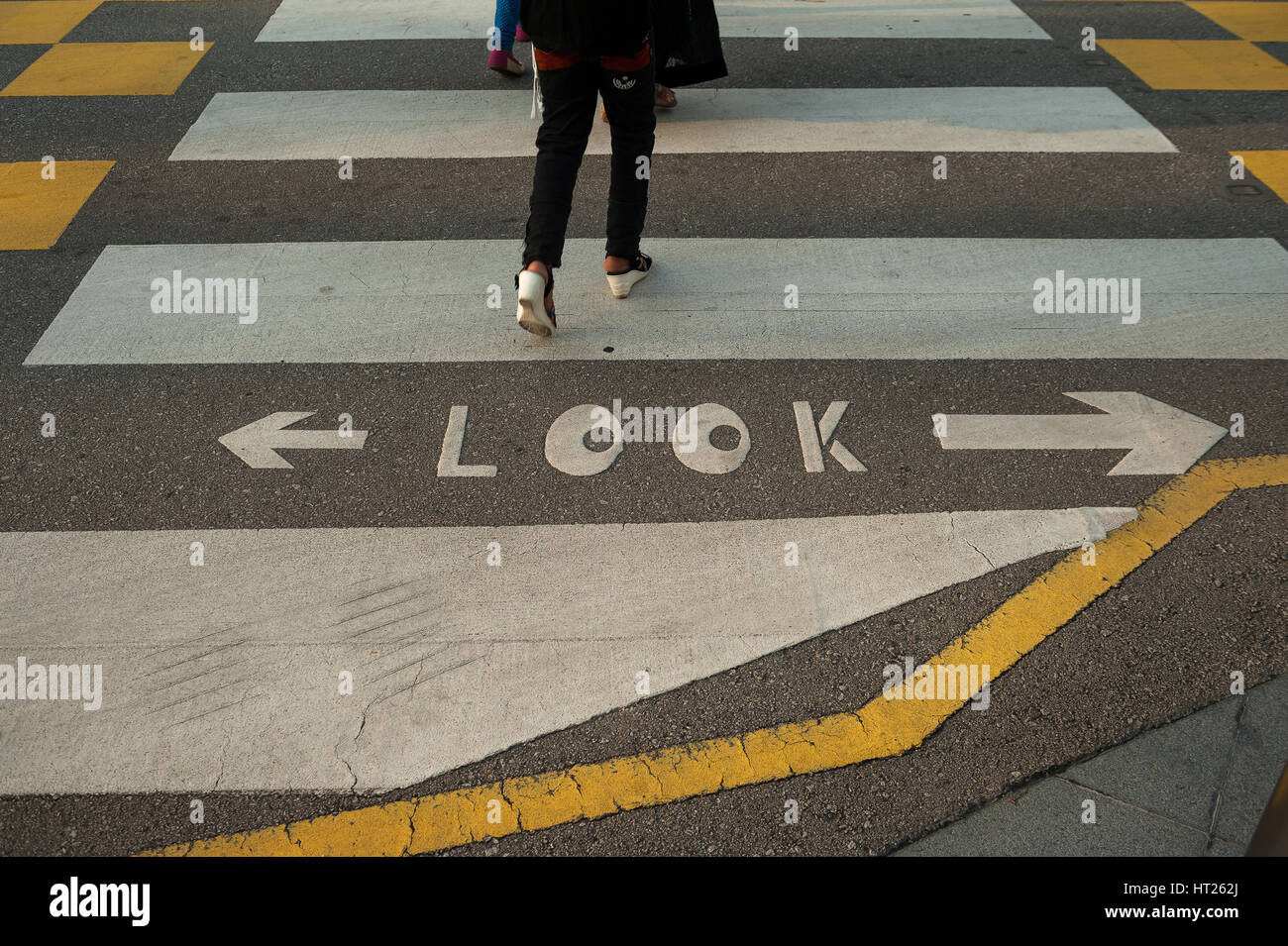 02.10.2016, Singapore, Republic of Singapore - People walk across a ...