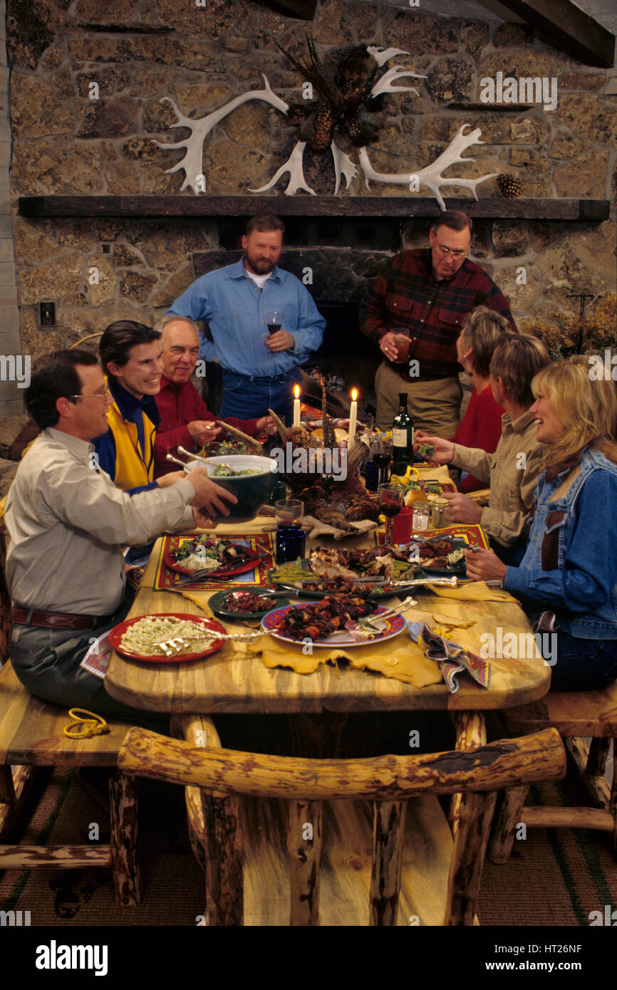 Friends and family gathered around the table for a dinner party Stock ...
