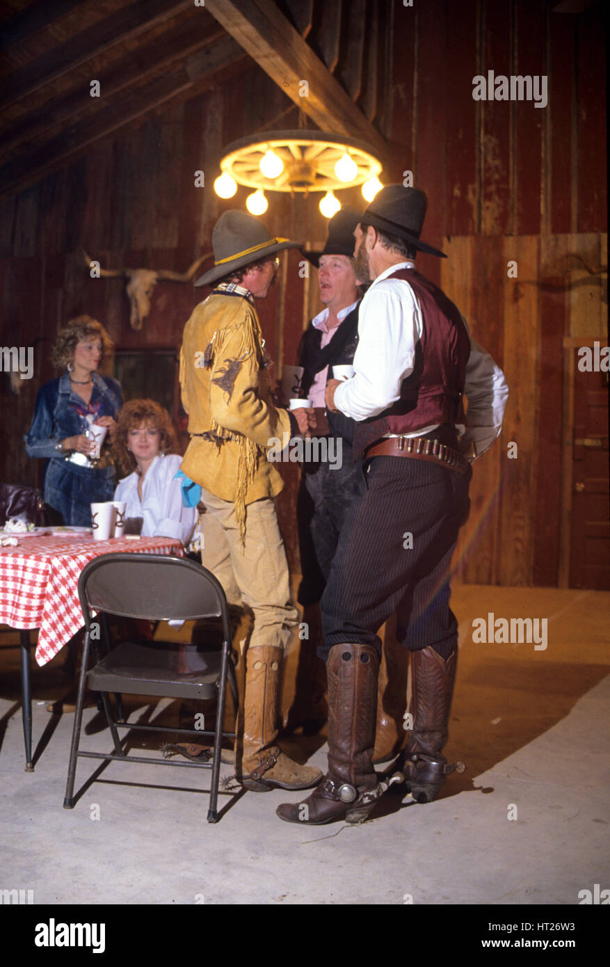 Group cowboys converse around table hi-res stock photography and images ...
