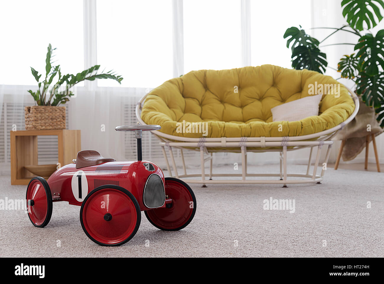 Interior room with sofa and toy car red color Stock Photo - Alamy