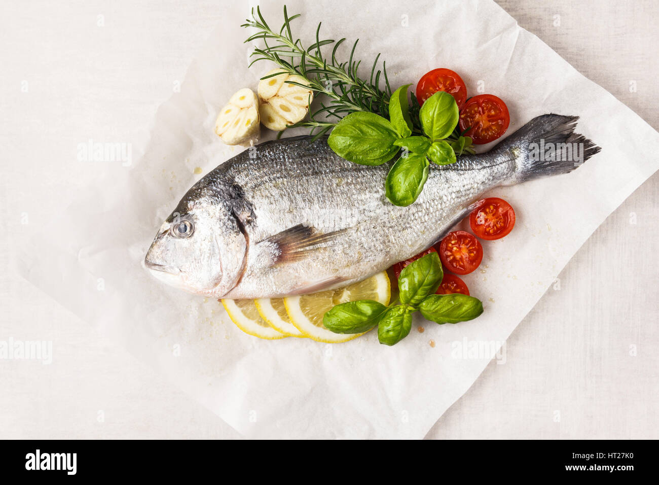 Raw fish cooking and ingredients. Dorado, lemon, herbs and spices. Top ...