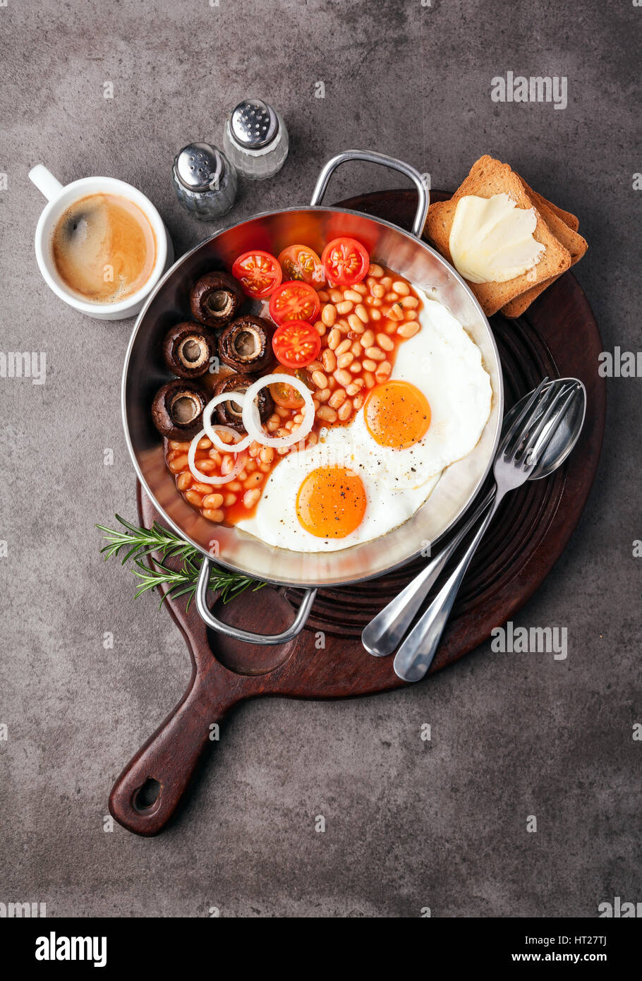 Full English Breakfast with fried eggs, beans, toasts, tomatoes ...