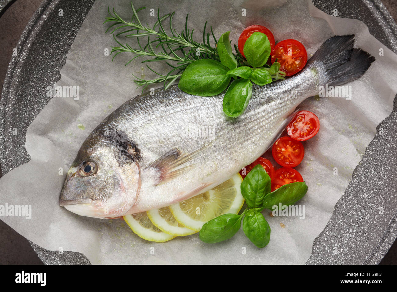 Raw fish cooking and ingredients. Dorado, lemon, herbs and spices. Top ...