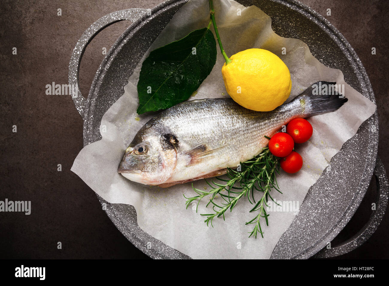 Raw fish cooking and ingredients. Dorado, lemon, herbs and spices. Top ...