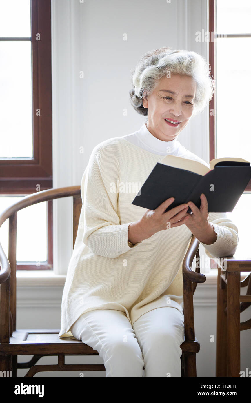 Happy senior woman reading a book Stock Photo - Alamy