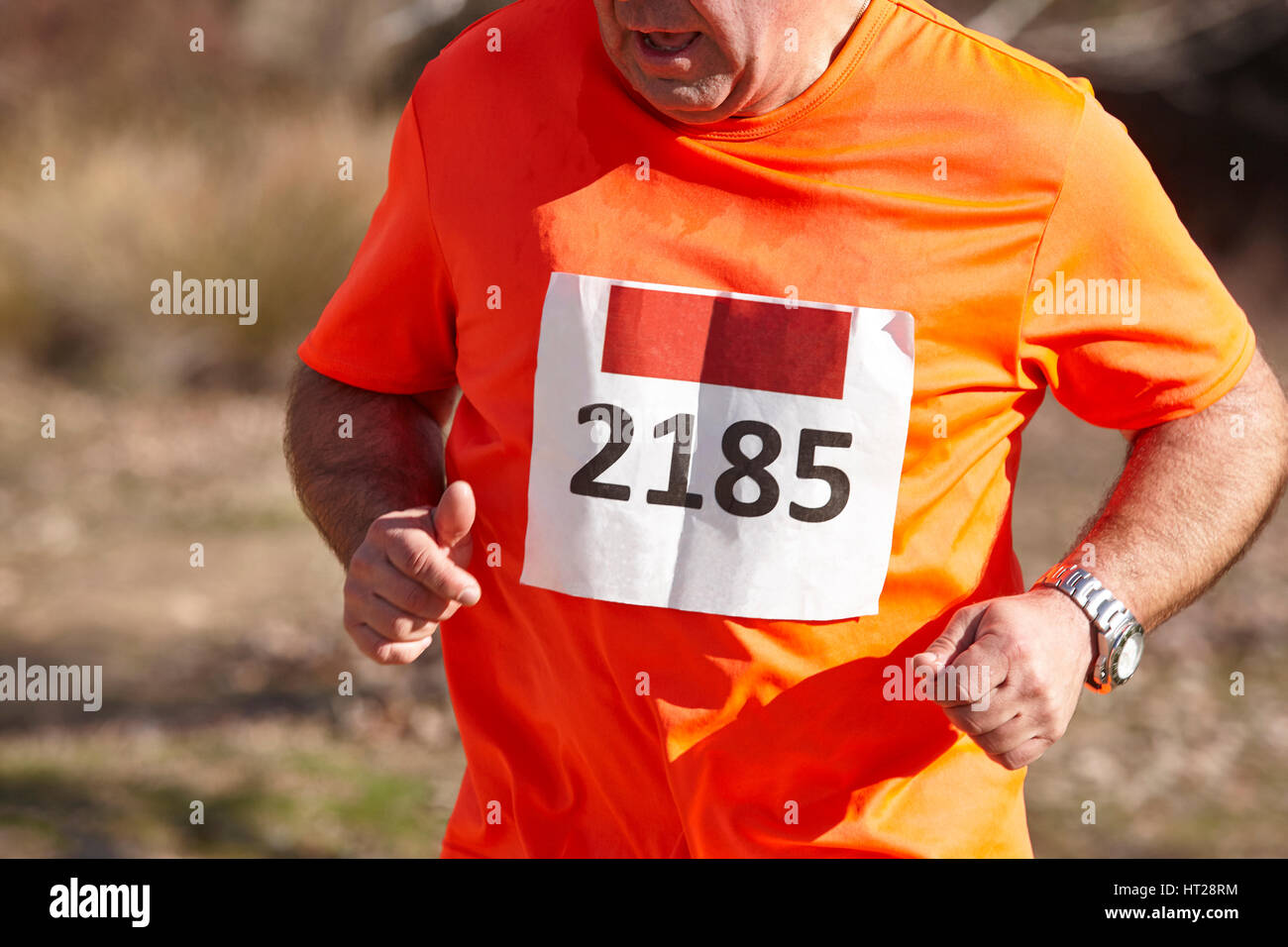 Senior athletic runner on a cross country race. Outdoor circuit ...