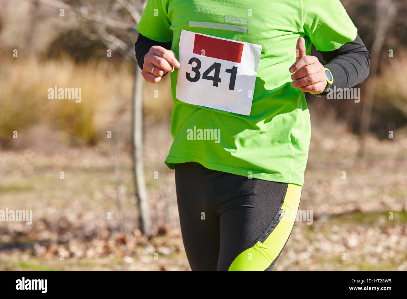 Male athletic runner on a cross country race. Outdoor circuit ...